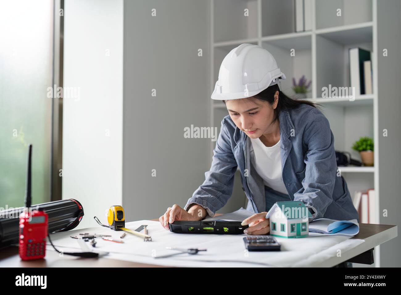 Civil Engineer Evaluating Construction Plans Using a Level for Accurate ...