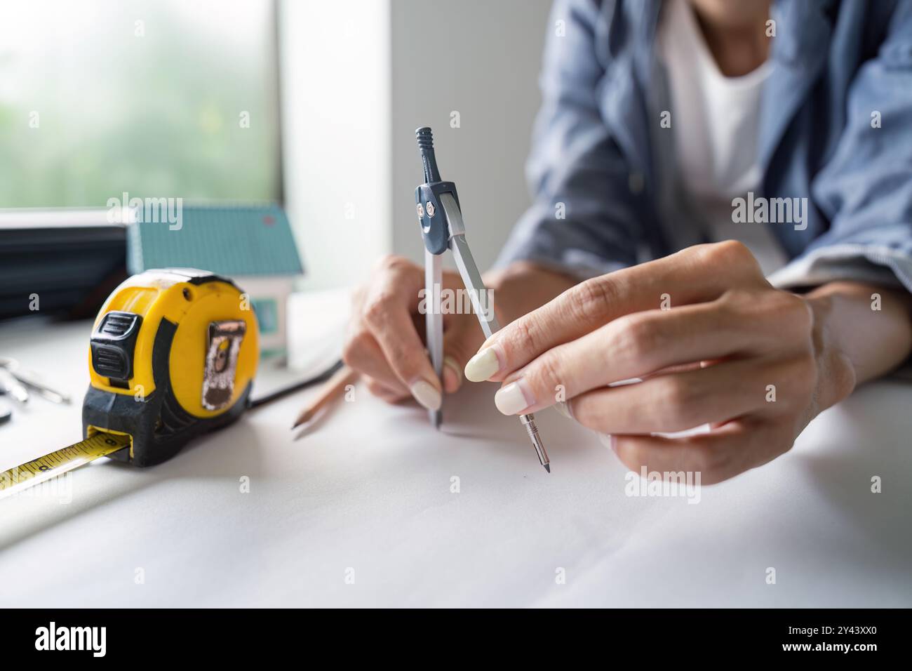 Architect Demonstrating Drafting Skills with a Compass for Building ...