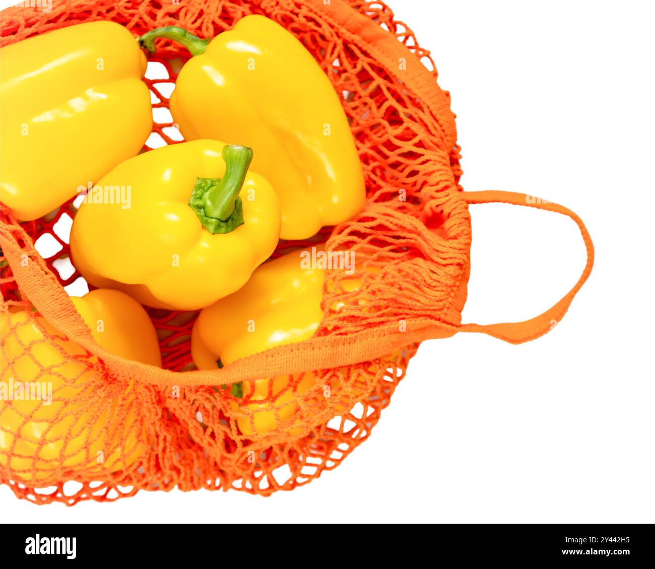 Yellow bell peppers in reusable orange mesh bags on transparent ...