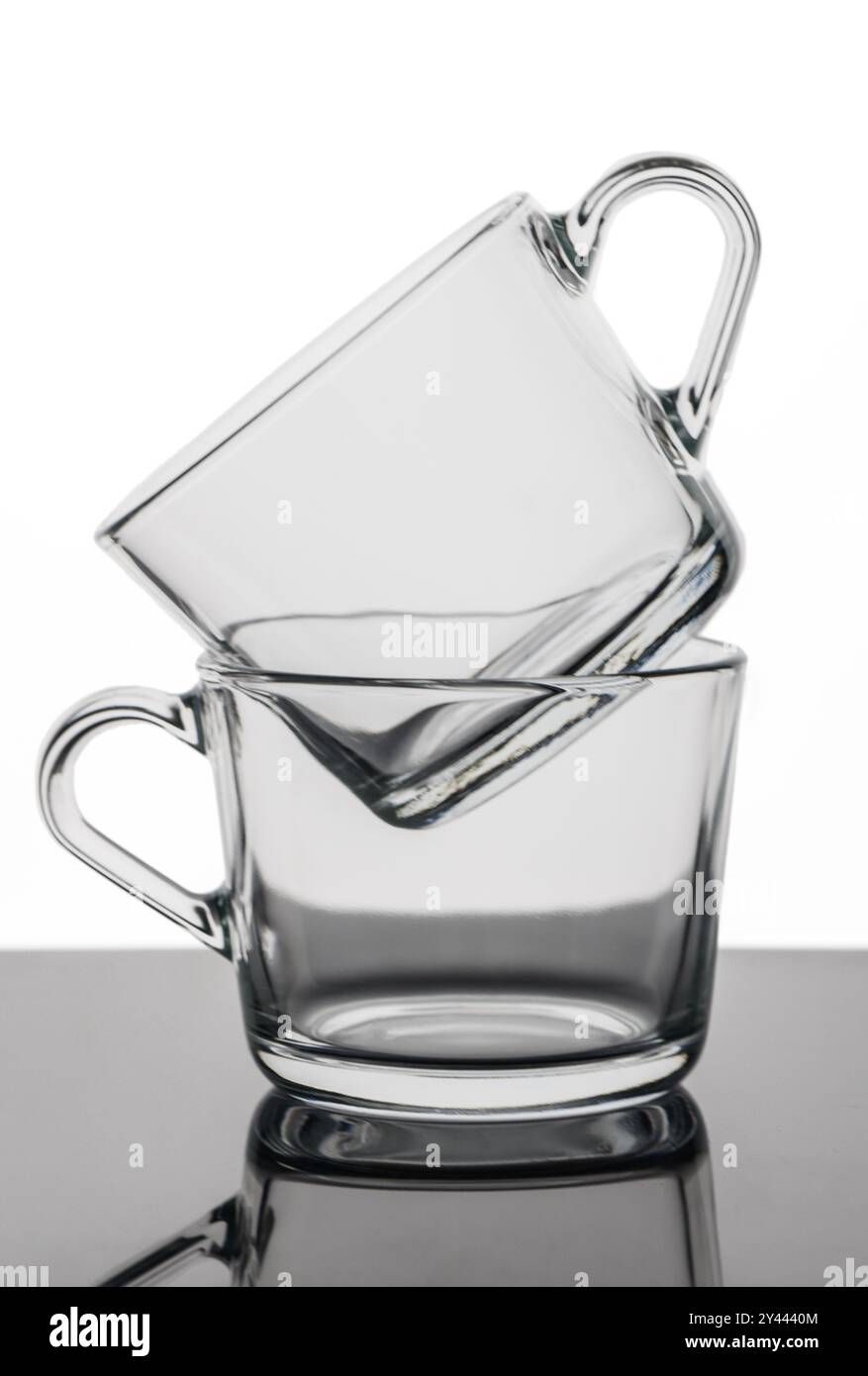 transparent tea cups stand one inside another on a white background ...