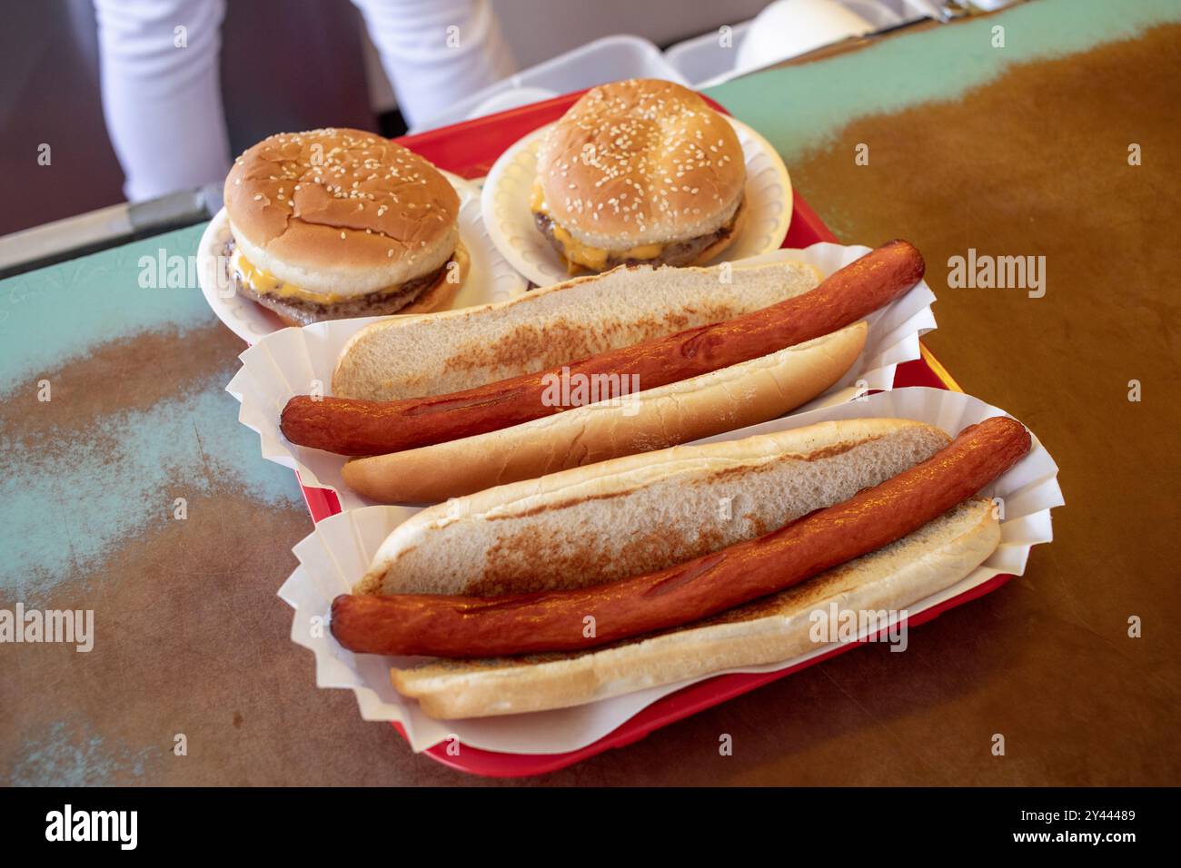 A cafeteria tray with footlong hot dogs and burgers Stock Photo - Alamy