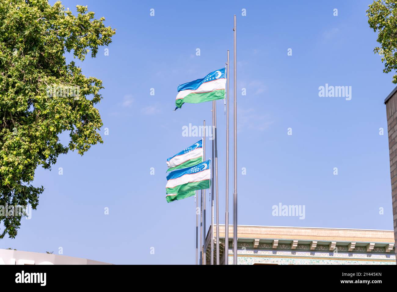Two flags are flying on a pole in front of a building Stock Photo - Alamy