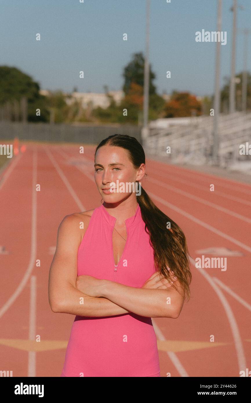 Female track athlete standing at starting line Stock Photo - Alamy