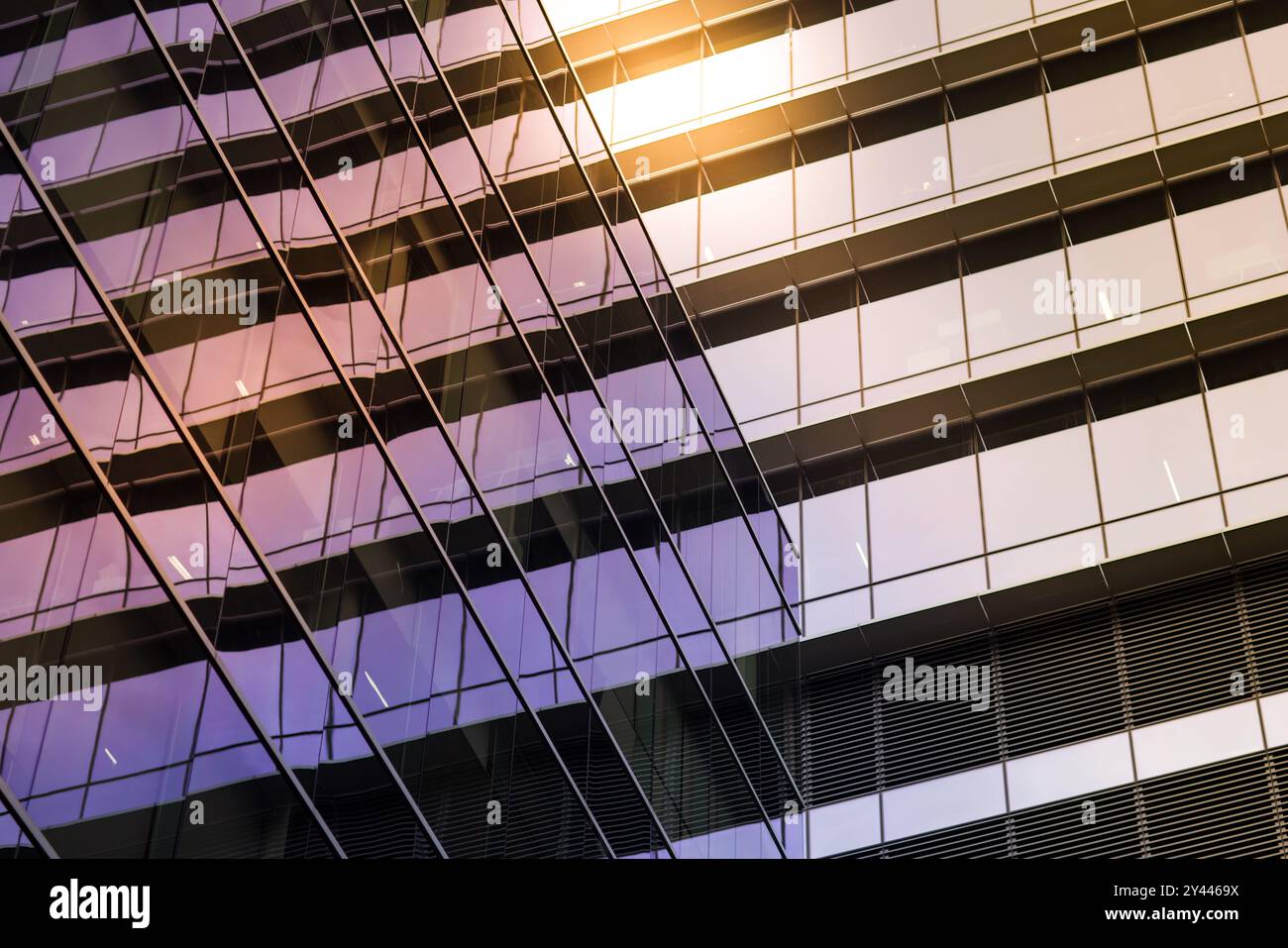 Reflective glass windows of a modern geometric building in sunlight ...