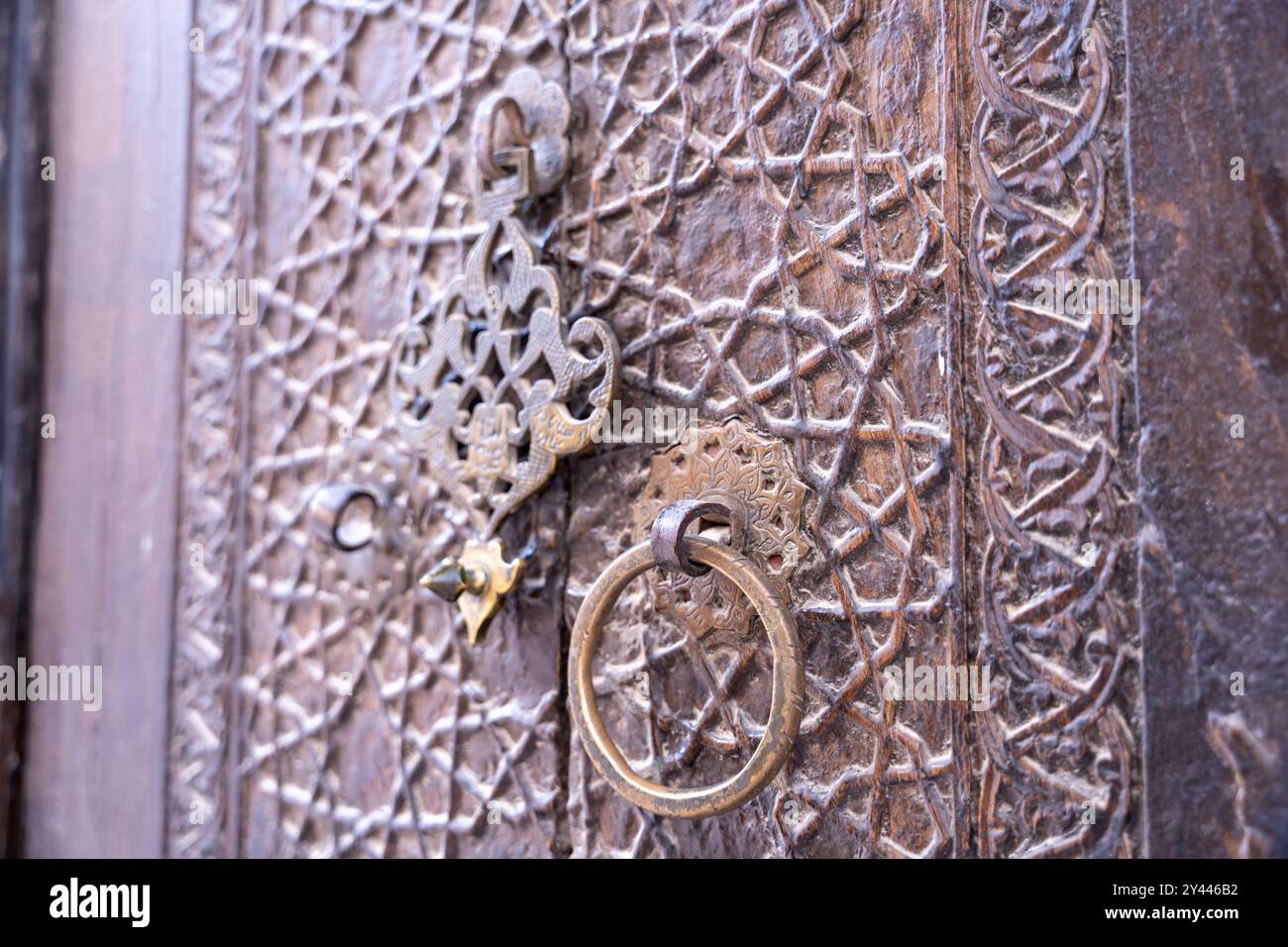 A wooden door with a gold and silver lock Stock Photo - Alamy