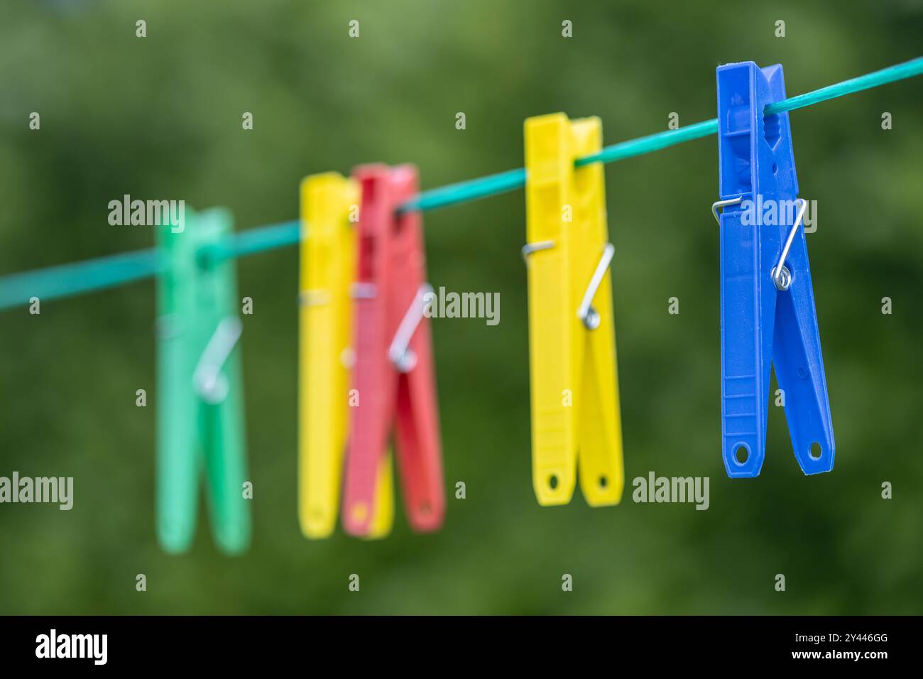 Plastic Colourful clothes pegs on a washing line Stock Photo - Alamy