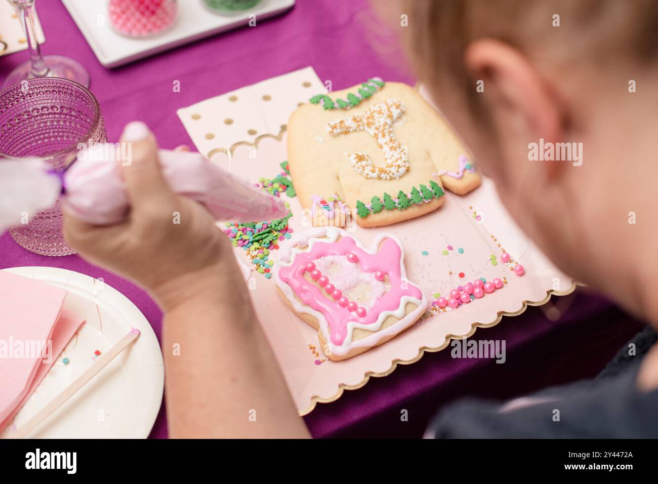 Woman decorating sugar cookies with icing Stock Photo - Alamy