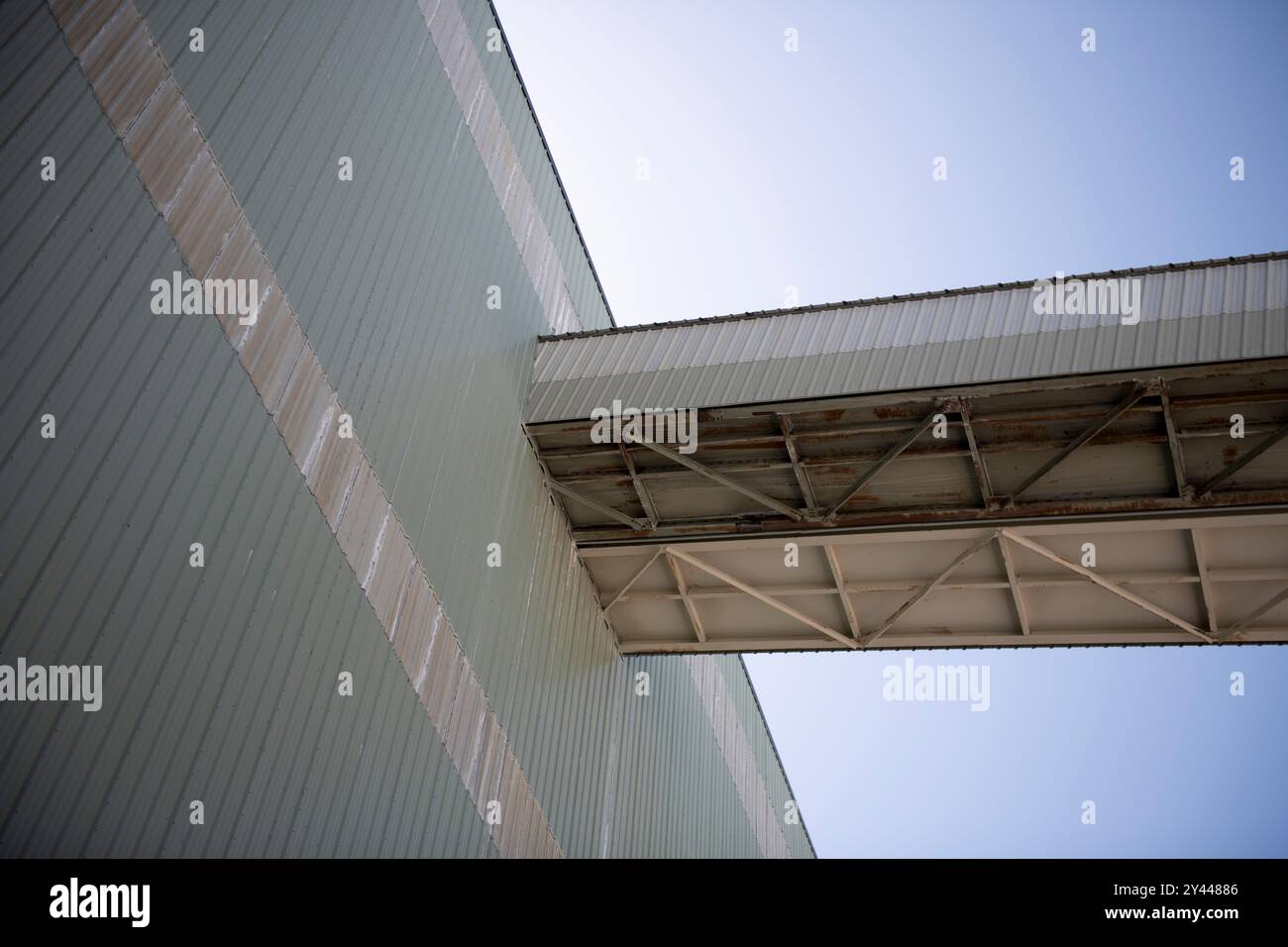 View of enclosed conveyor from underneath from an industrial building ...