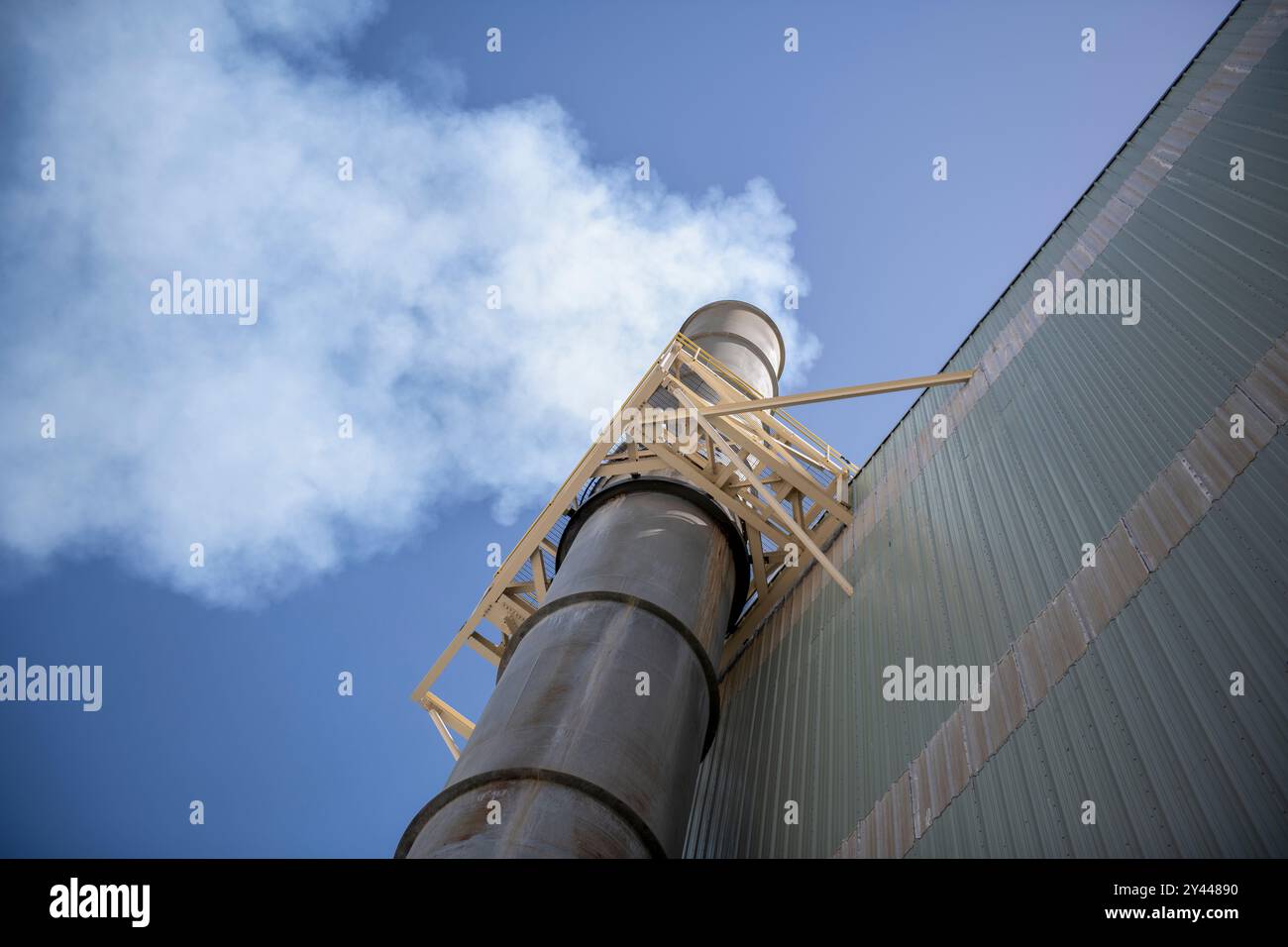 Smoke steam rising and dissipating from industrial plant smokestack ...