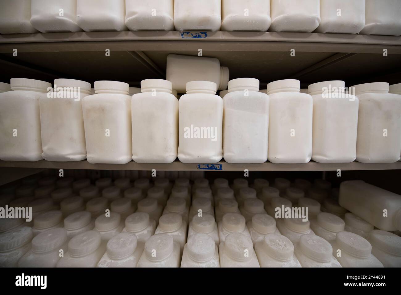 Shelves full of containers with white powder compound samples Stock ...
