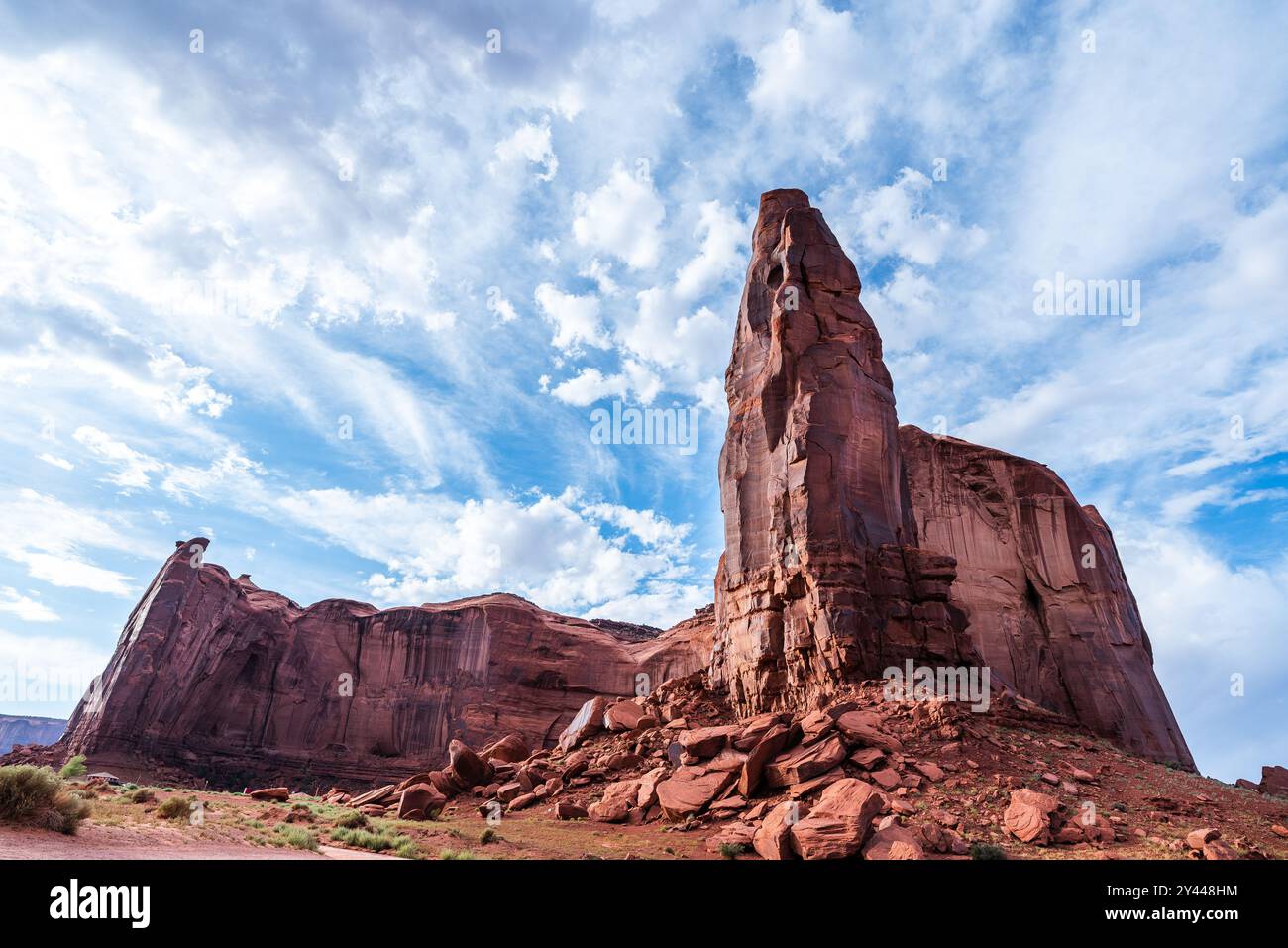 Towering red rock spire under a dramatic sky in Monument Valley Stock ...