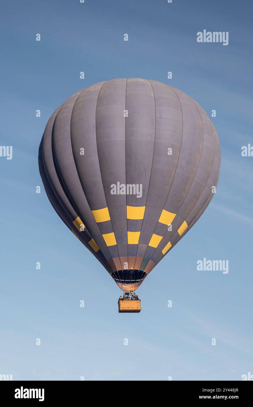A big, hot air balloon, floating in a blue summers sky Stock Photo - Alamy