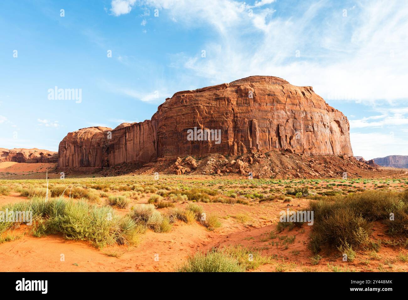 Massive sandstone formation under a bright sky in Monument Valley Stock ...