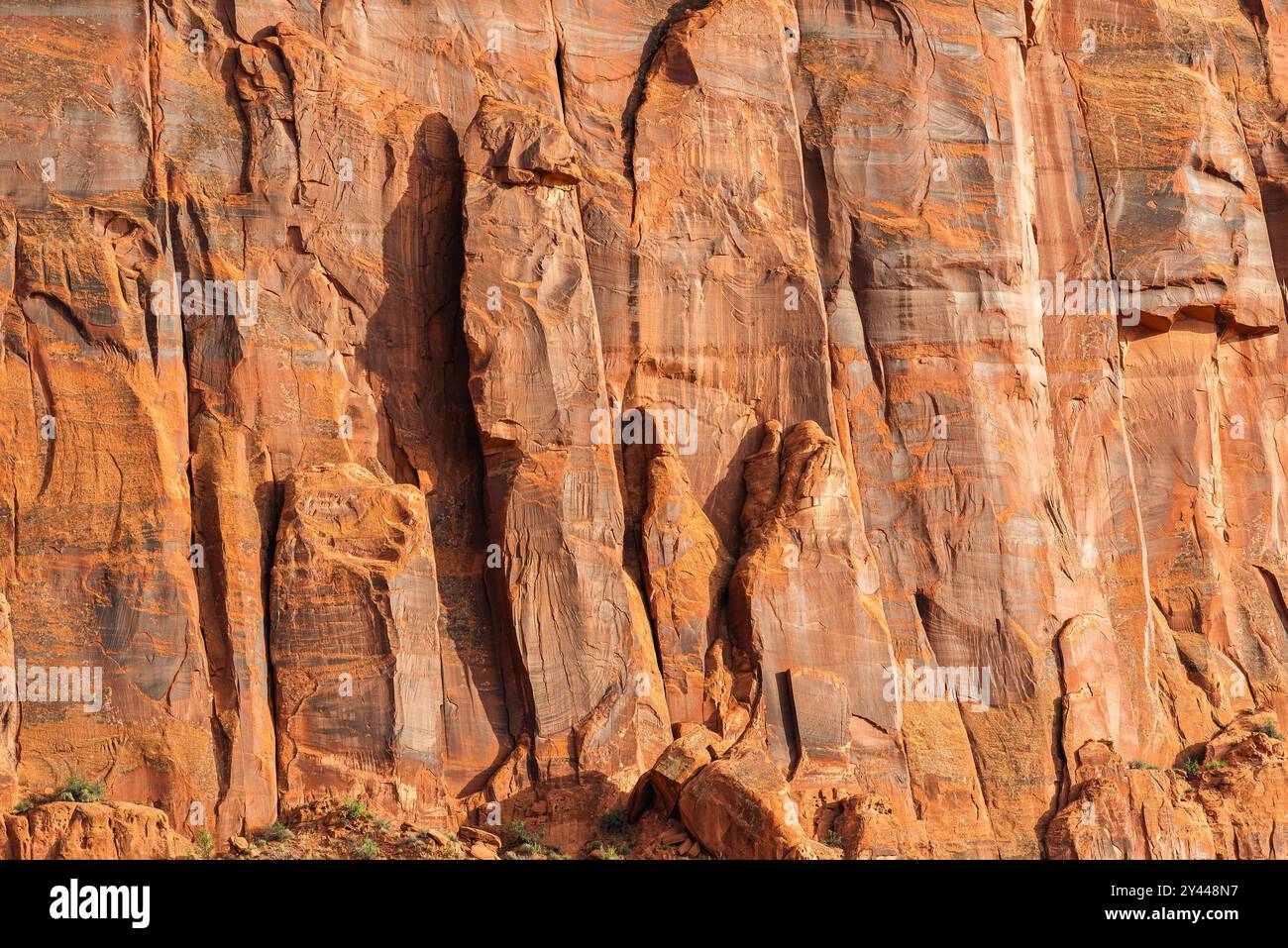 Layered sandstone cliffs with warm hues in Monument Valley Stock Photo ...