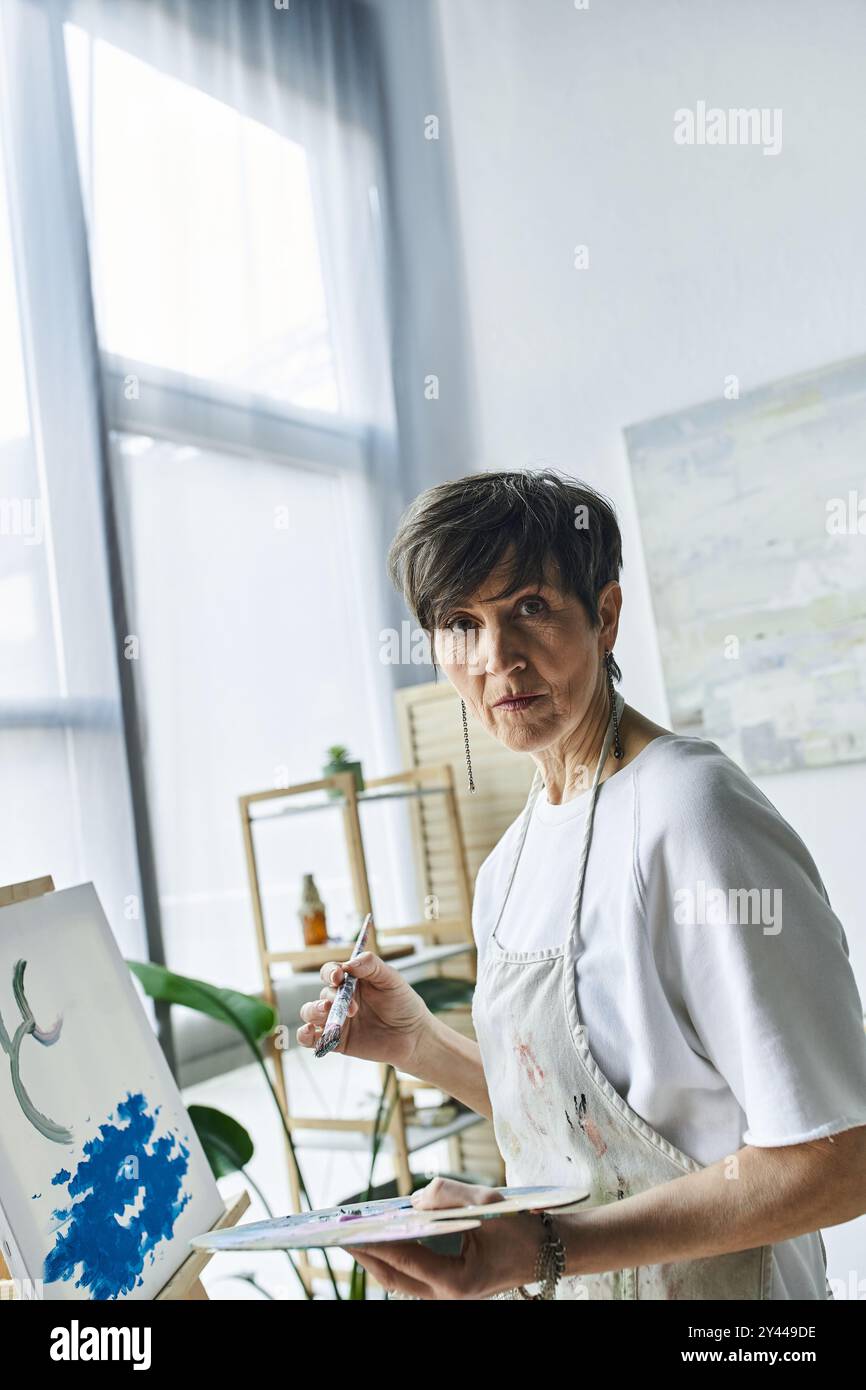A dedicated painter captures inspiration in her airy art studio Stock ...