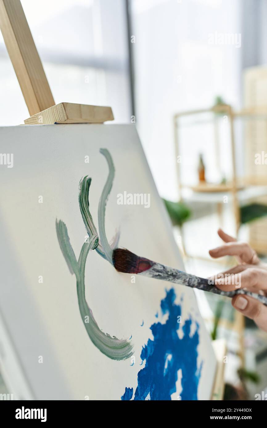 A dedicated artist immerses herself in creativity at her studio Stock ...