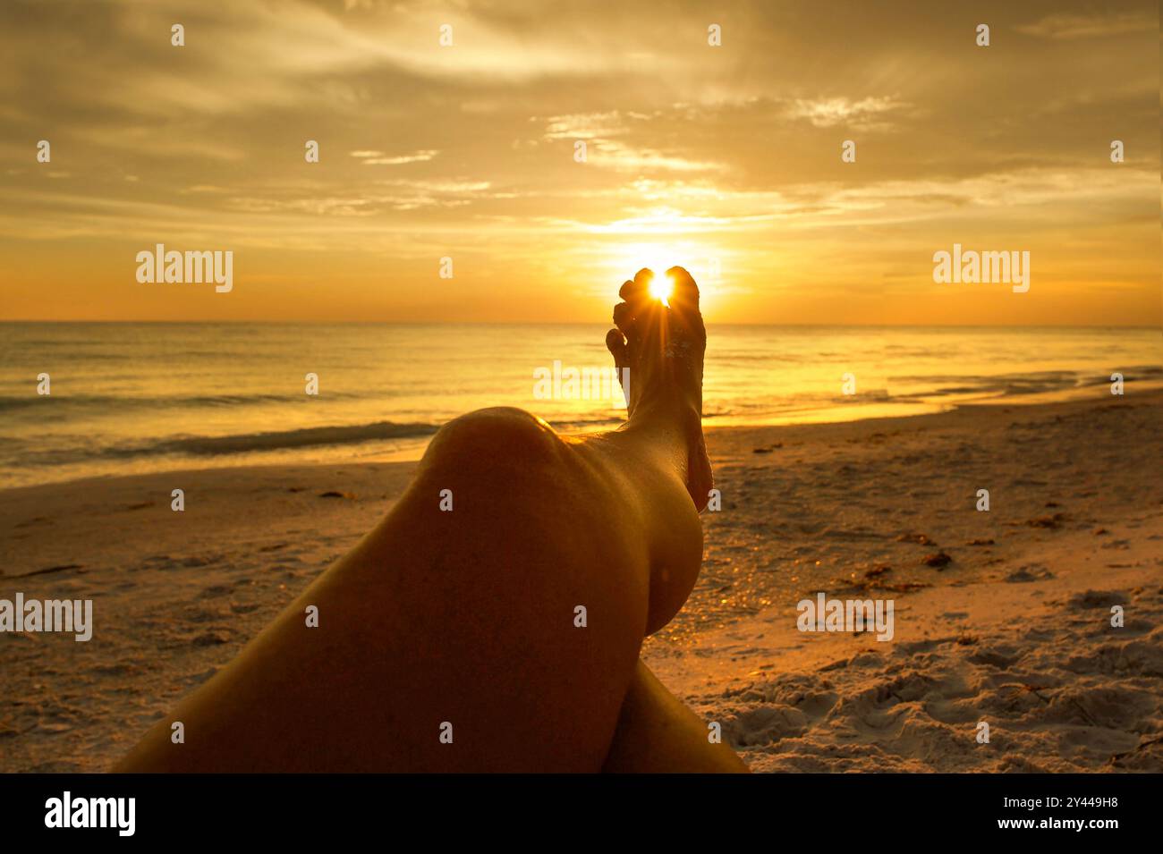 Toes in the sand at sunset Anna Maria Island Stock Photo - Alamy