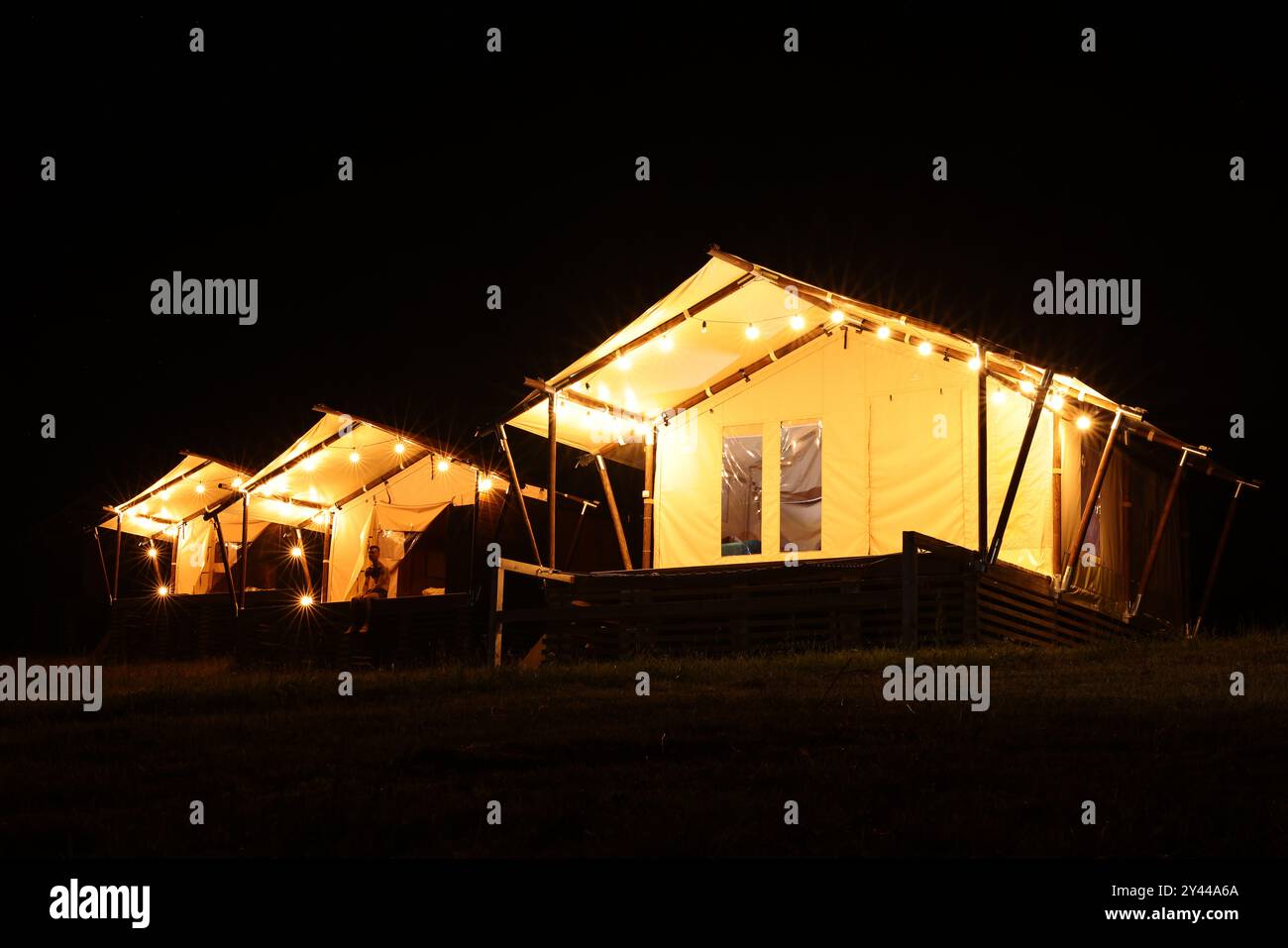 Tents in mountains at night. Glamping site Stock Photo - Alamy
