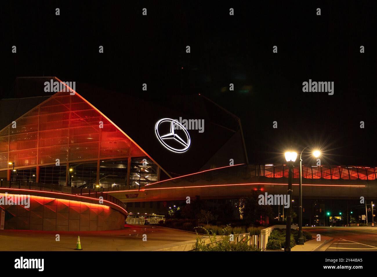 A Mercedes-Benz Stadium is lit up in red lights. The building is ...