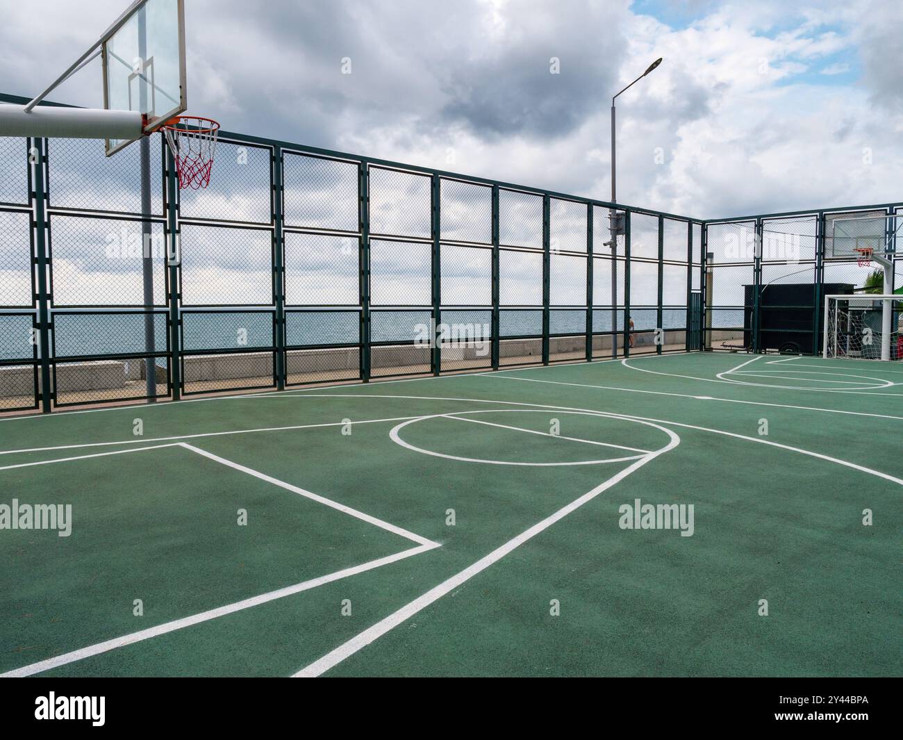 A basketball court is located by the seaside. The court's design ...