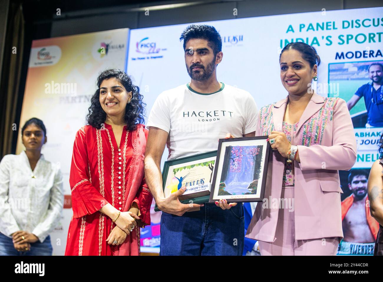 NEW DELHI, INDIA - SEPTEMBER 11: Boxer Vijender Singh (C) and Payal Kanodia, Chairperson of YFLO ...