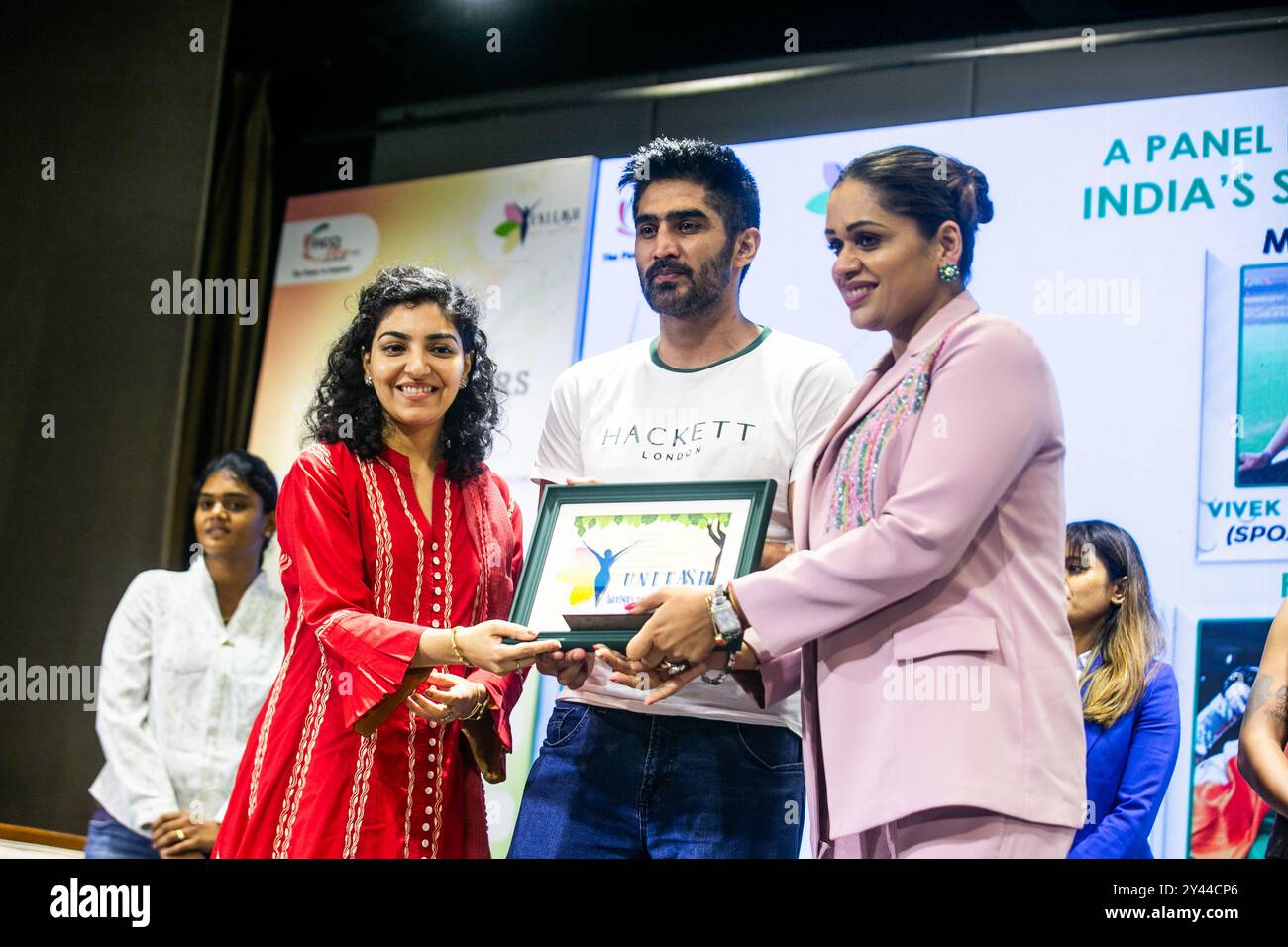 NEW DELHI, INDIA - SEPTEMBER 11: Boxer Vijender Singh (C) and Payal Kanodia, Chairperson of YFLO ...