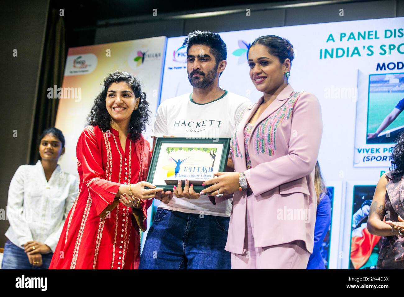 NEW DELHI, INDIA - SEPTEMBER 11: Boxer Vijender Singh (C) and Payal Kanodia, Chairperson of YFLO ...