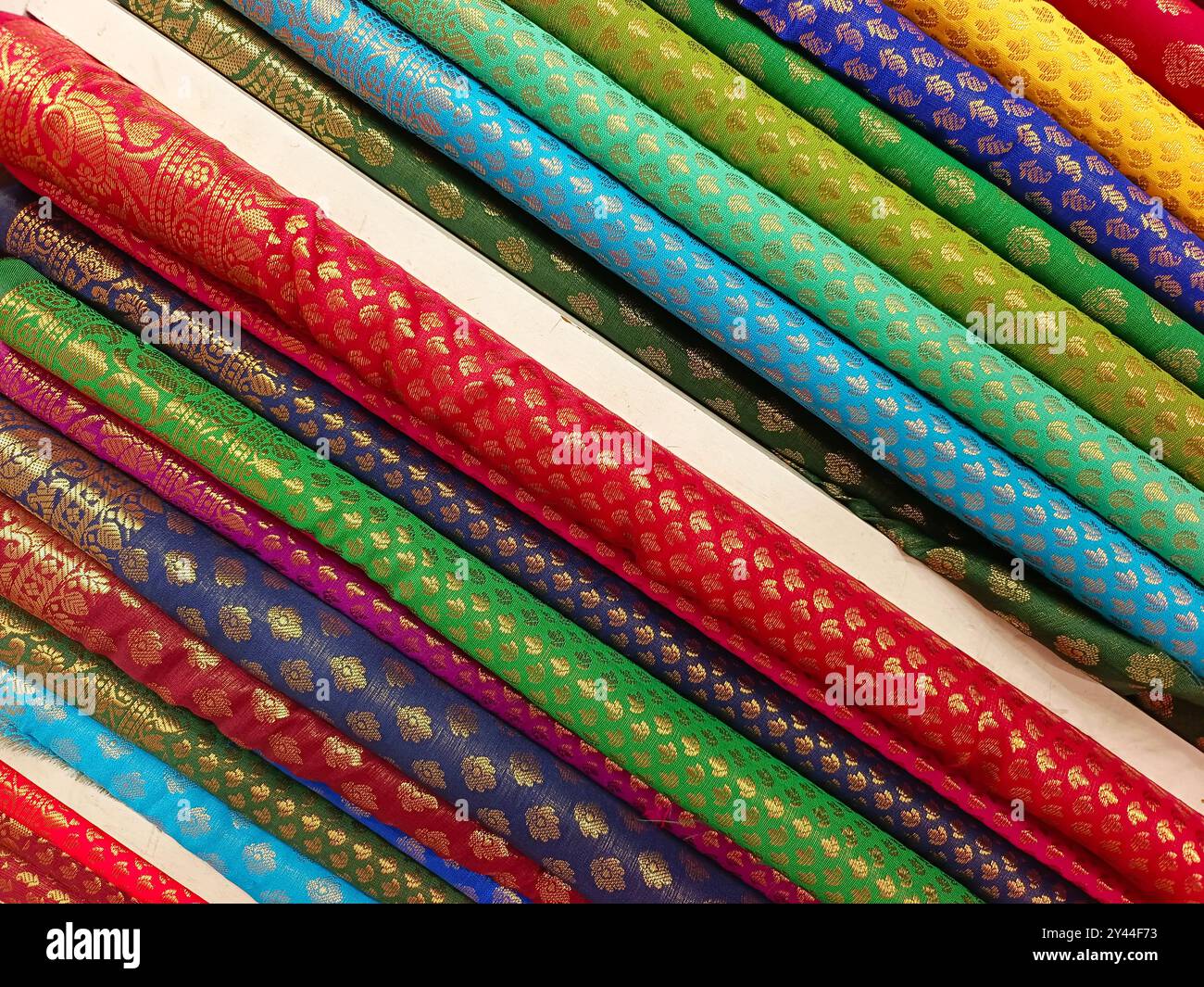 Pallet of vivid and colorful Indian fabric, Closeup view of stacked ...