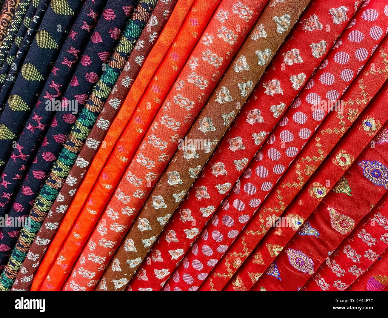 Pallet of vivid and colorful Indian fabric, Closeup view of stacked ...