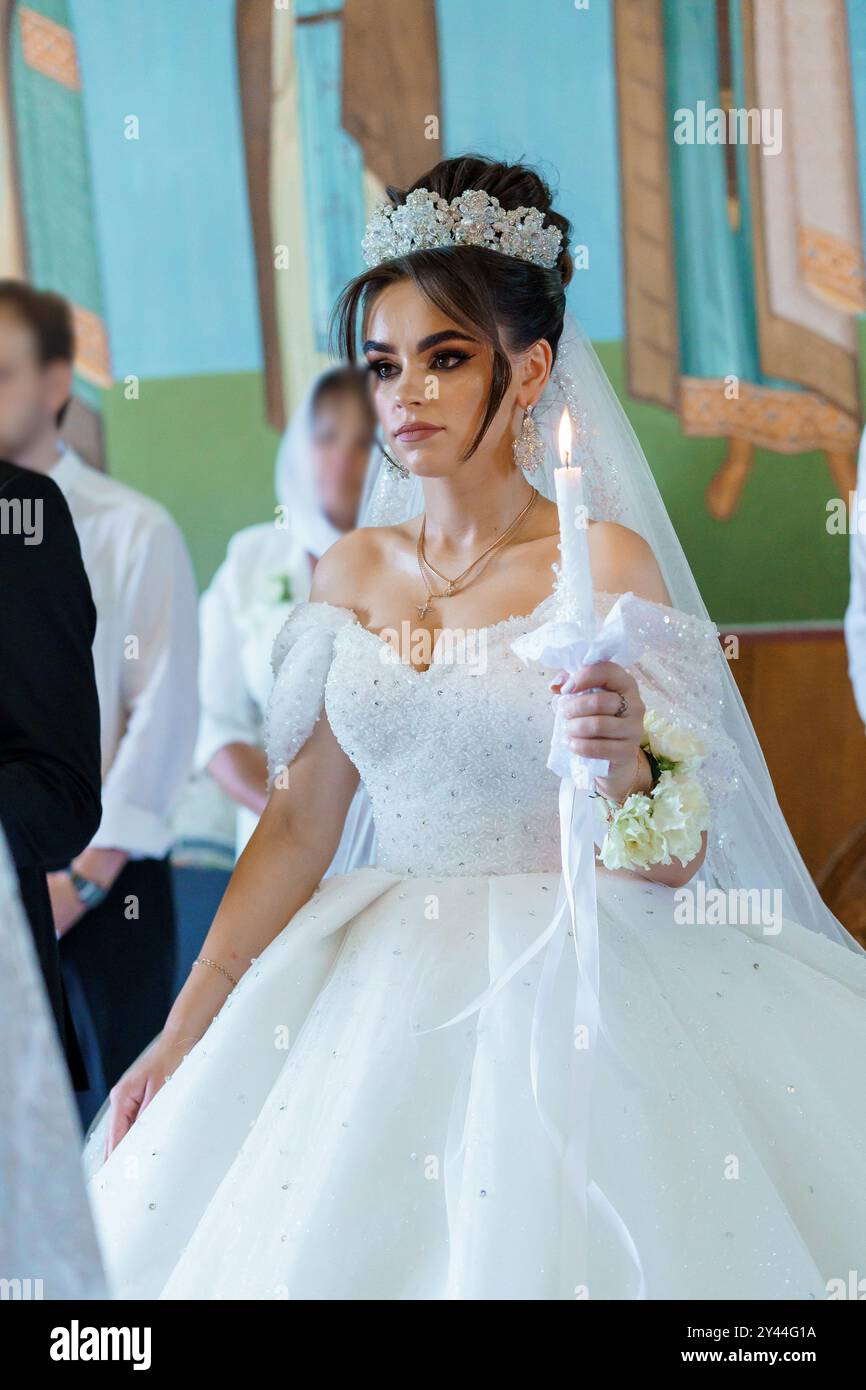 Elegant Bride Holding Candle in a Stunning White Wedding Gown During ...