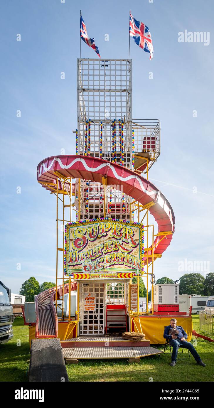 Super high Helter Skelter slide ride at British carnival funfair on ...