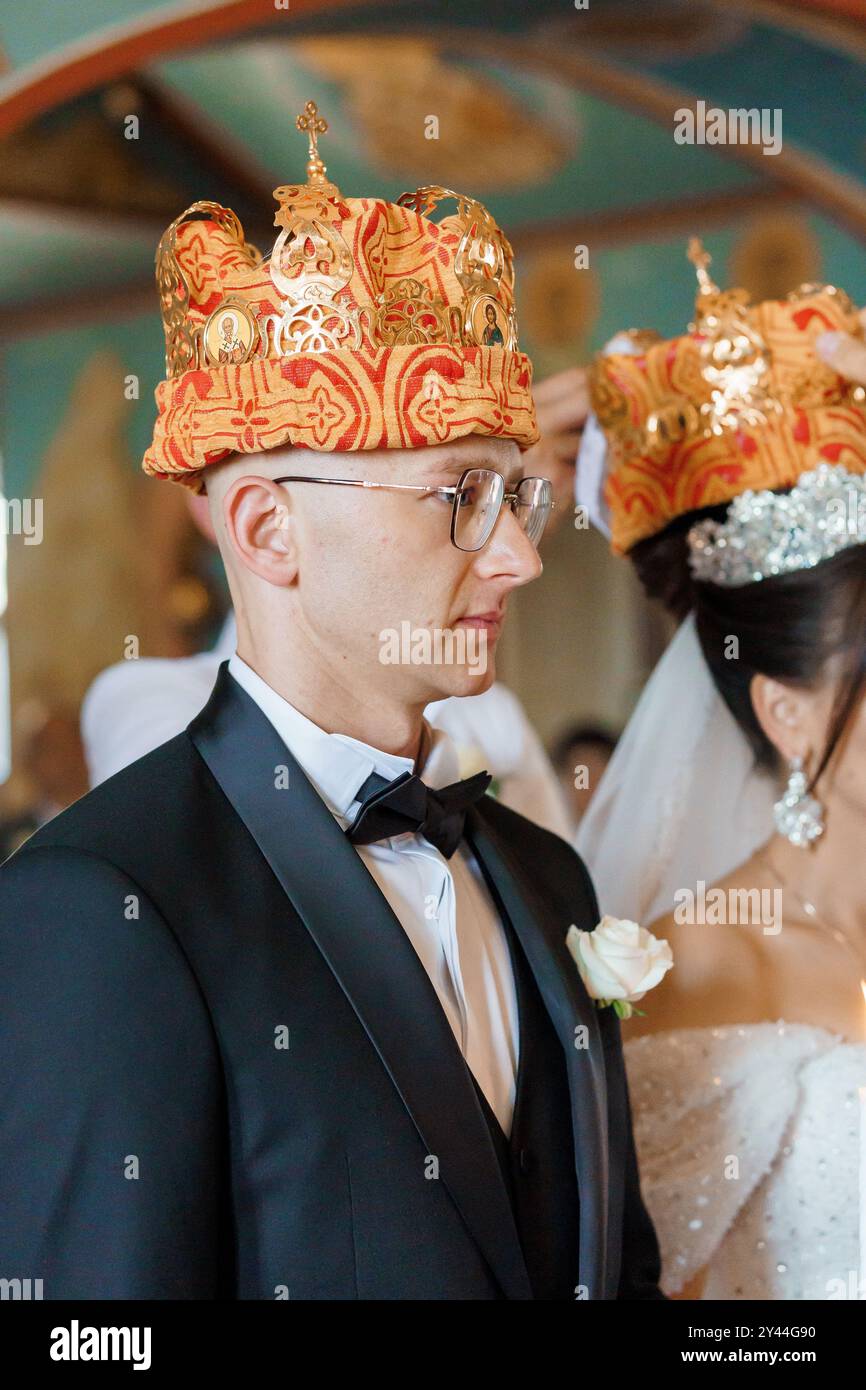 Elegant Wedding Ceremony with Traditional Crowns and Attire in a ...