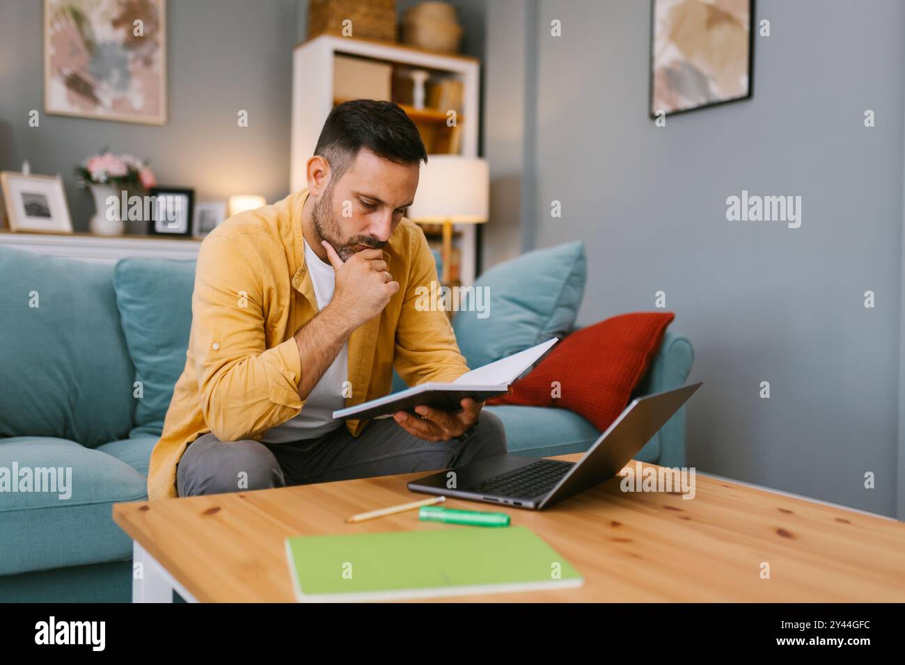 Happy aged man indoor working at laptop and smiling hi-res stock ...