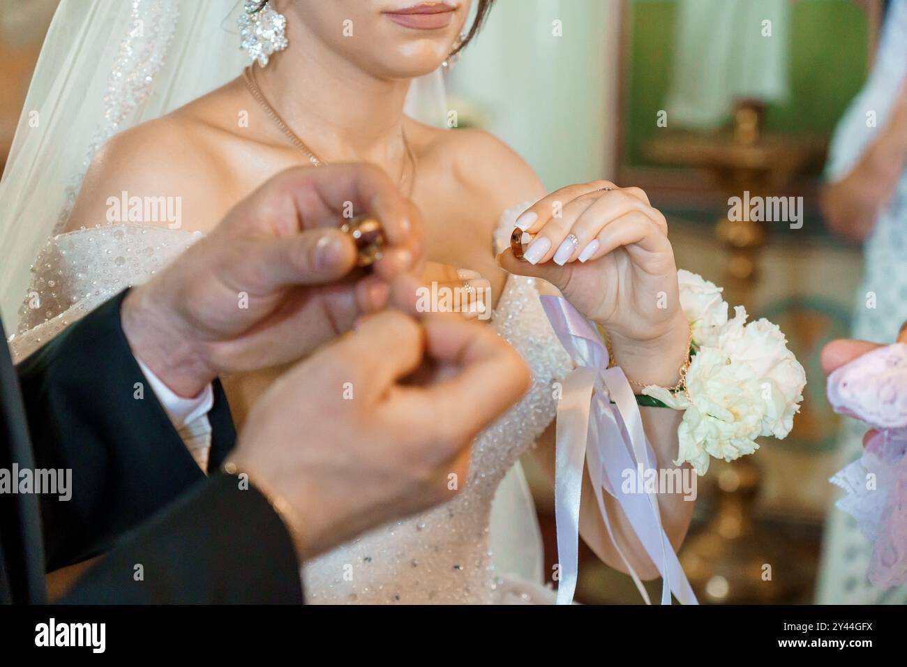 Elegant Wedding Ceremony Moment with Bride and Groom Exchanging Rings ...