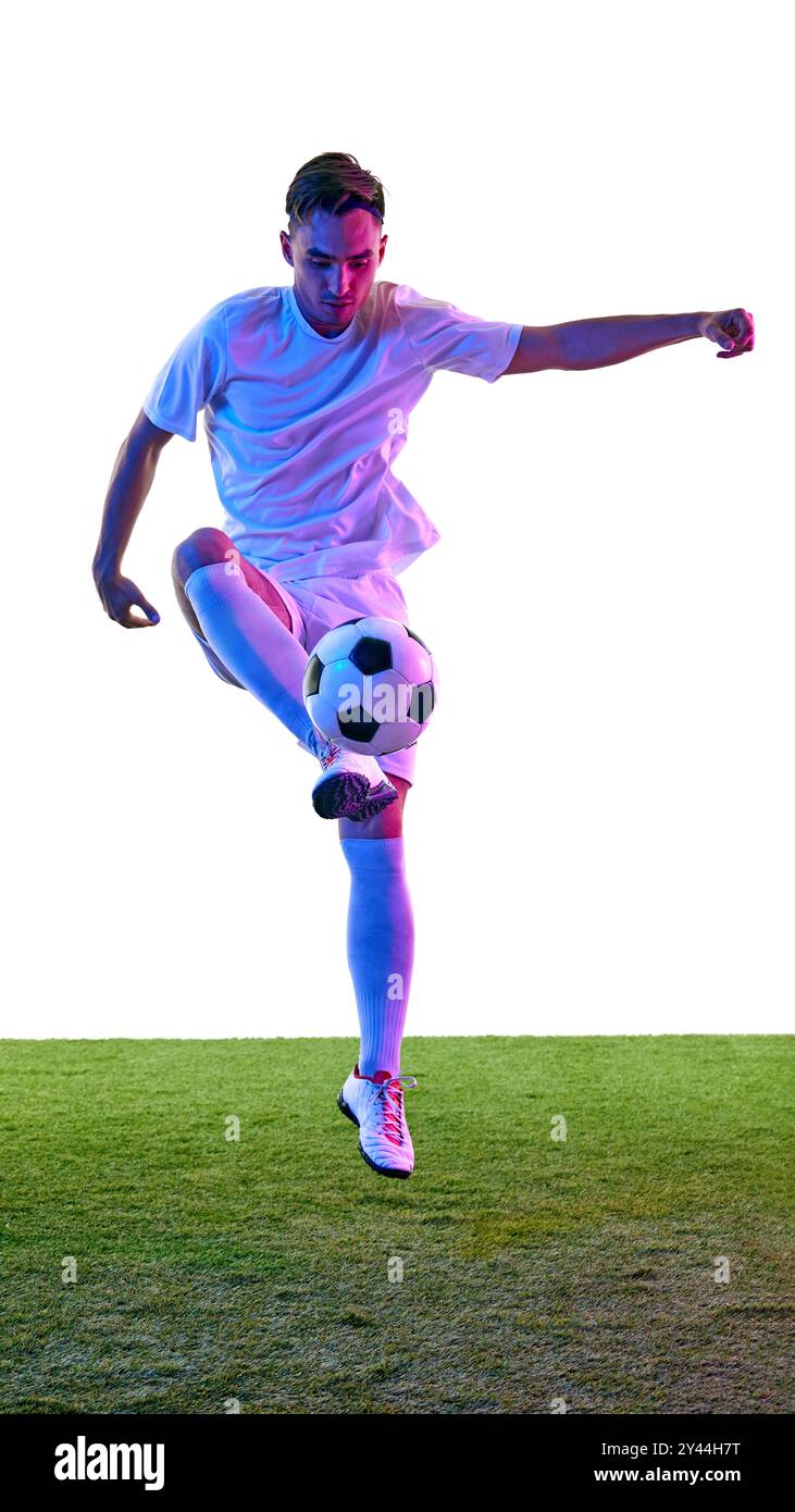 Athletic young man practicing ball control. With focused intensity, he ...