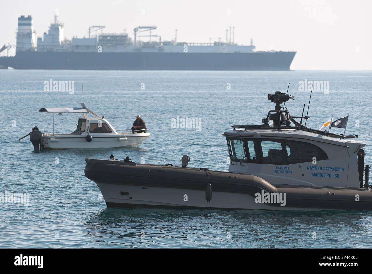 Limassol Coast guard motorboat patrolling with cargo ship in the ...