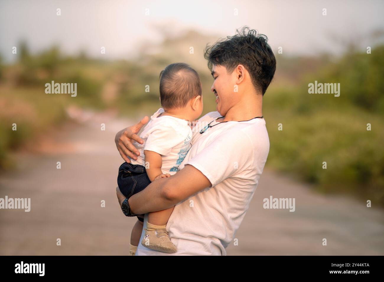 Dad smiled warmly at the baby boy. father holding and hugging baby boy ...