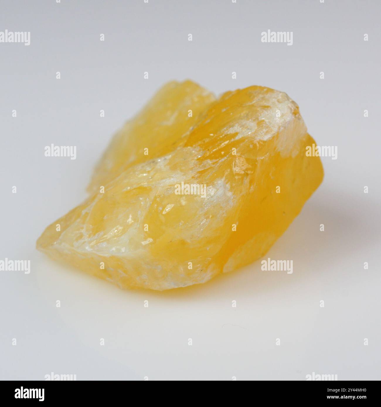 Radiant Yellow Calcite Crystal on Pristine White Background Stock Photo ...