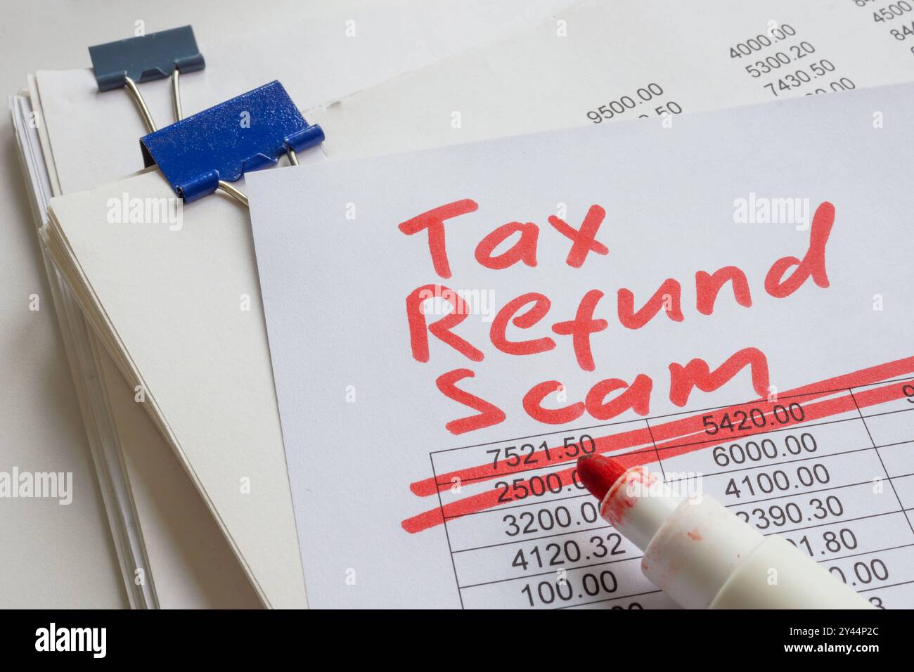 Stack of papers with the label tax refund scam Stock Photo - Alamy