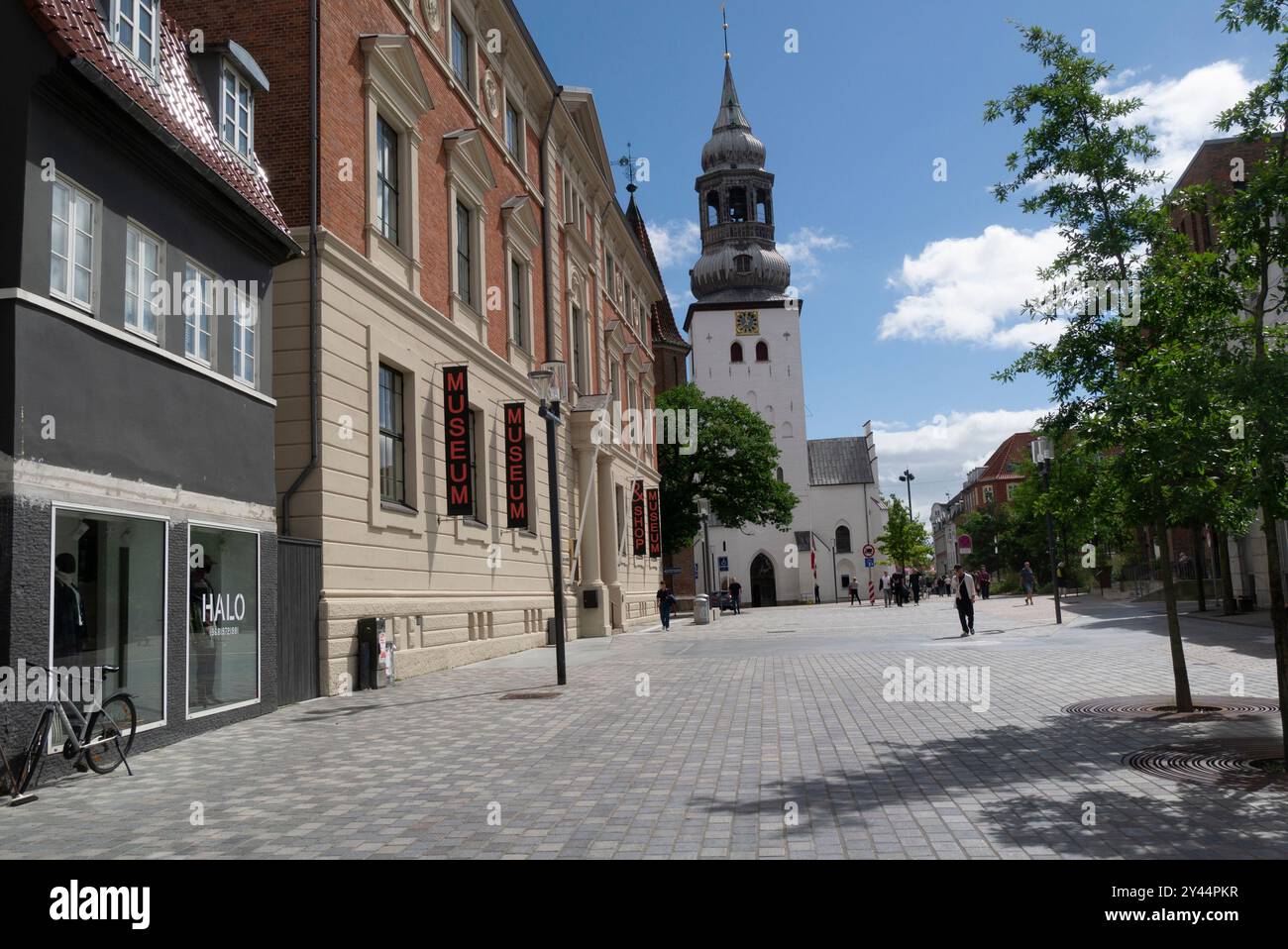 View along Budolfi Plads to Historical Museum and shop and Budolfi Cathedral Aalborg Denmark ...