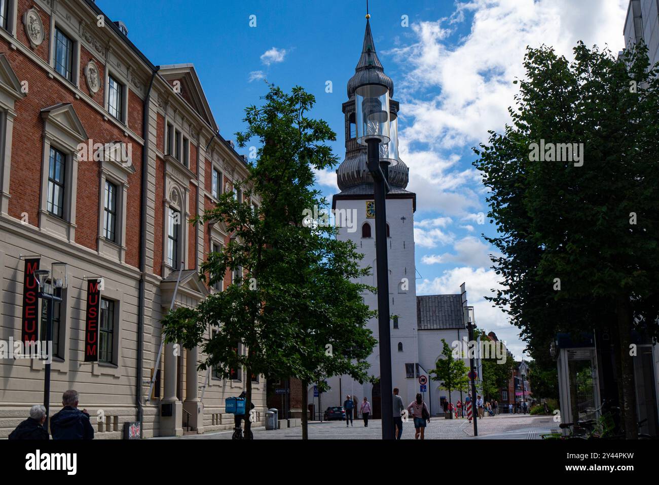 View along Budolfi Plads to Historical Museum and shop and Budolfi Cathedral Aalborg Denmark on ...