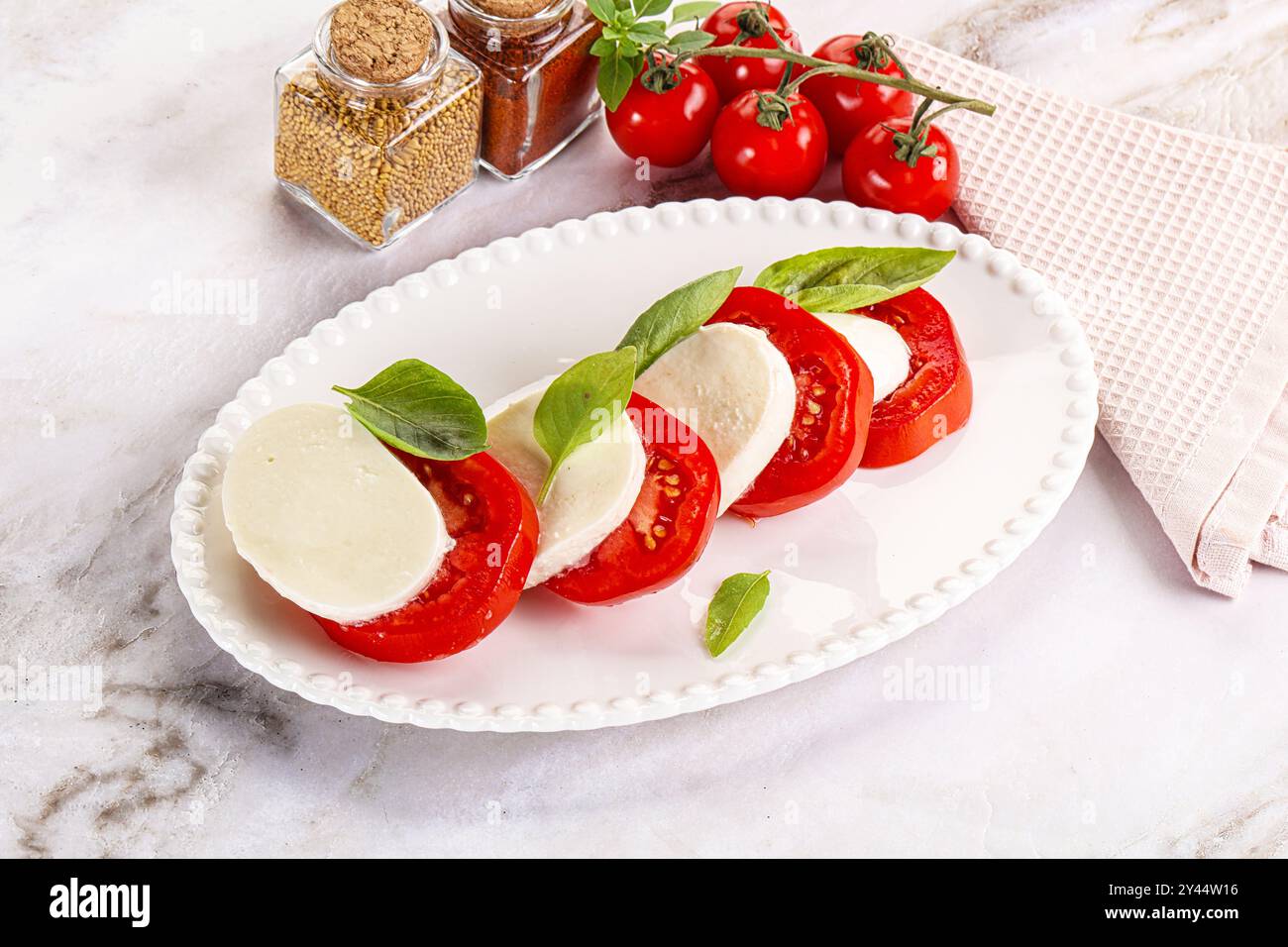 Italian caprese salad with mozzarella, tomato and basil Stock Photo - Alamy