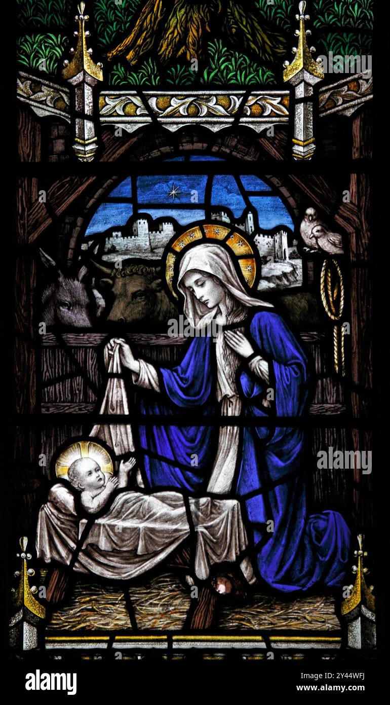 Mary with the baby Jesus in the crib, as depicted in a church stained ...