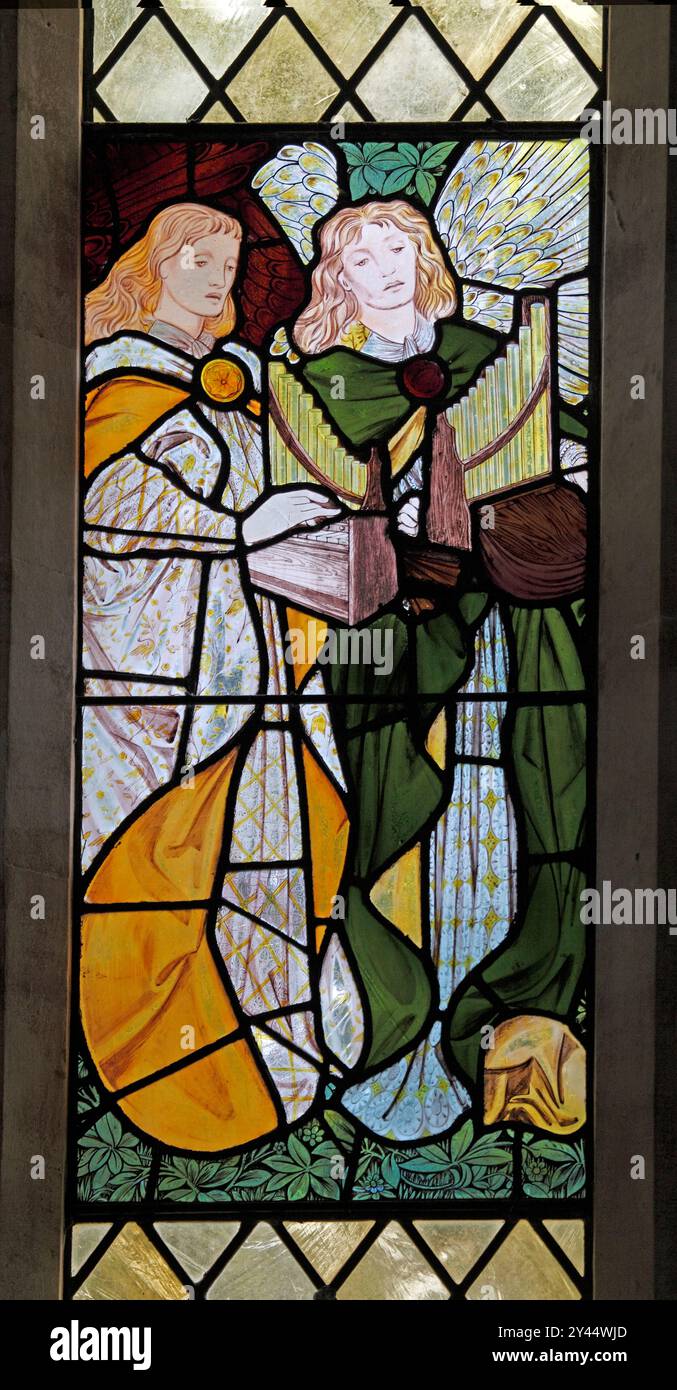 A stained glass window depictingtwo portable reed organs Stock Photo ...