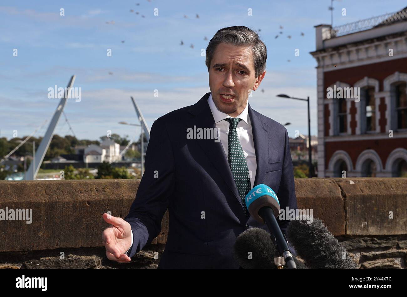 Taoiseach Simon Harris speaking to the media on the Derry Walls during ...