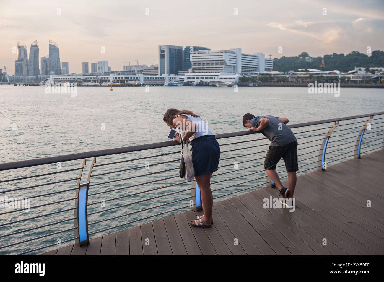 02.10.2016, Singapore, Republic of Singapore, Asia - Two people lean ...
