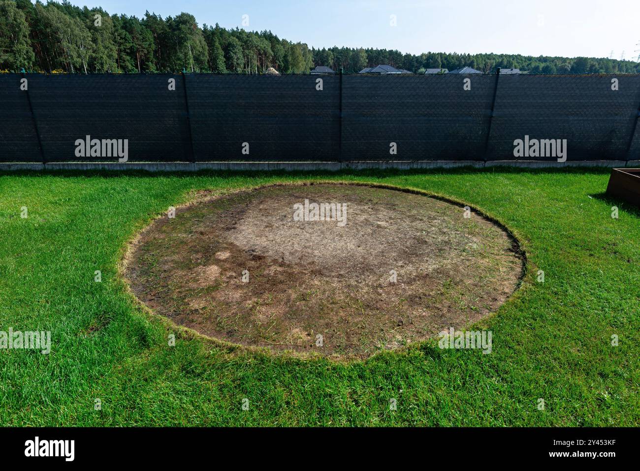 A burn mark on the lawn from the round outdoor swimming pool in the ...