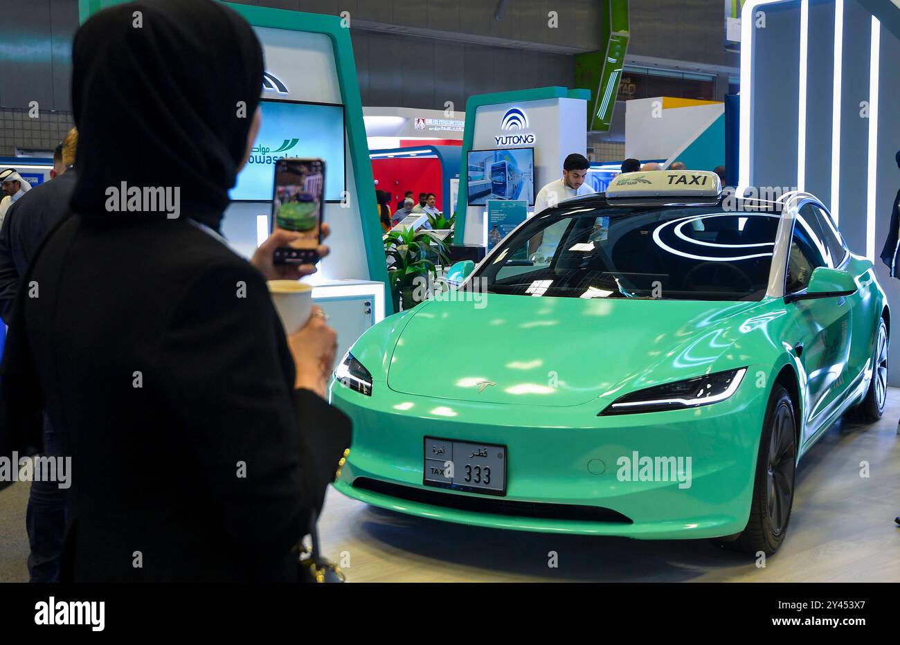 THE CONTEQ EXPO24 OPENING IN DOHA A visiter takes a picture of Tesla ...