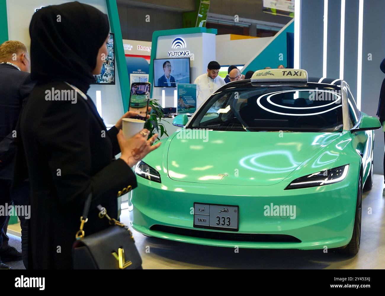 THE CONTEQ EXPO24 OPENING IN DOHA A visiter takes a picture of Tesla ...