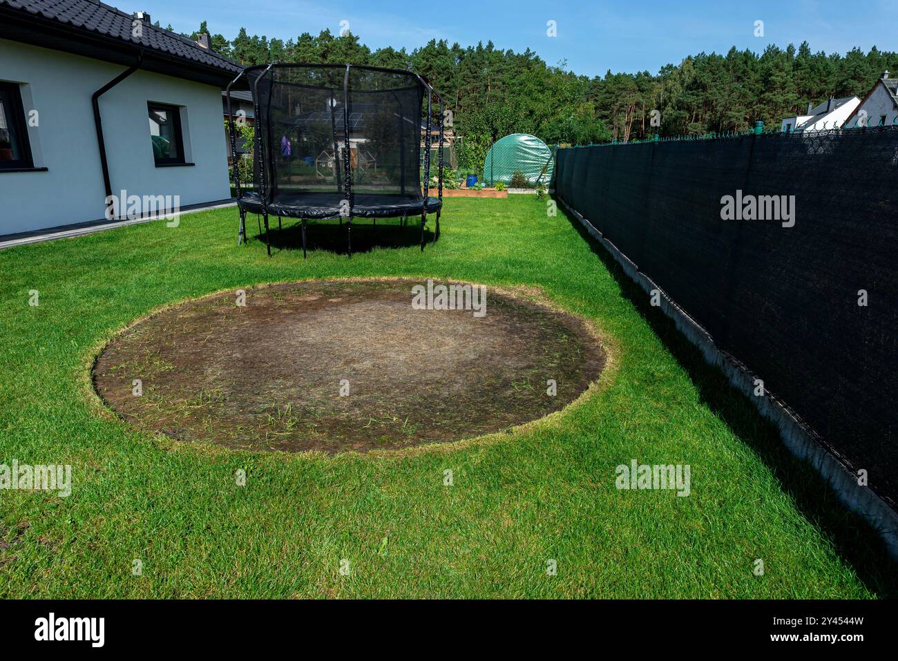A burn mark on the lawn from the round outdoor swimming pool in the ...
